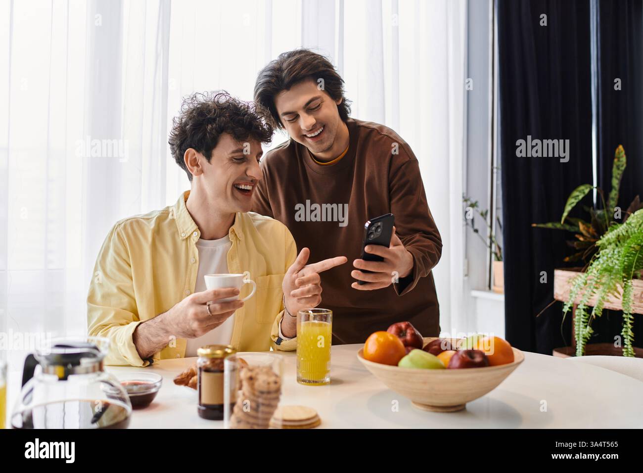 gay couple shares laughter and happiness while enjoying breakfast in ...