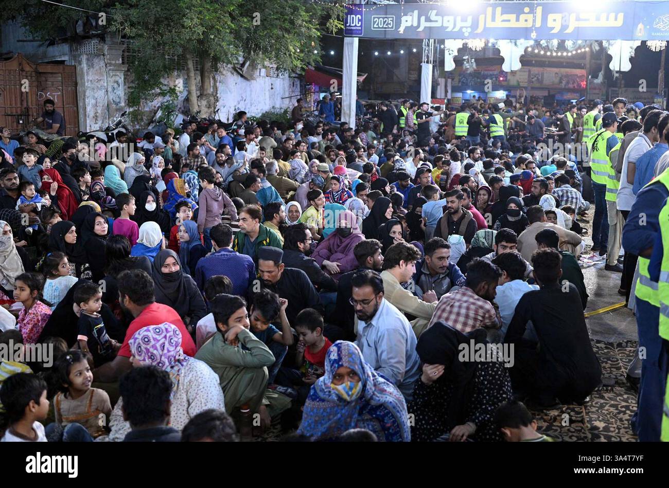 Faithful Muslims are breaking the fast (Iftar) under the supervision of ...