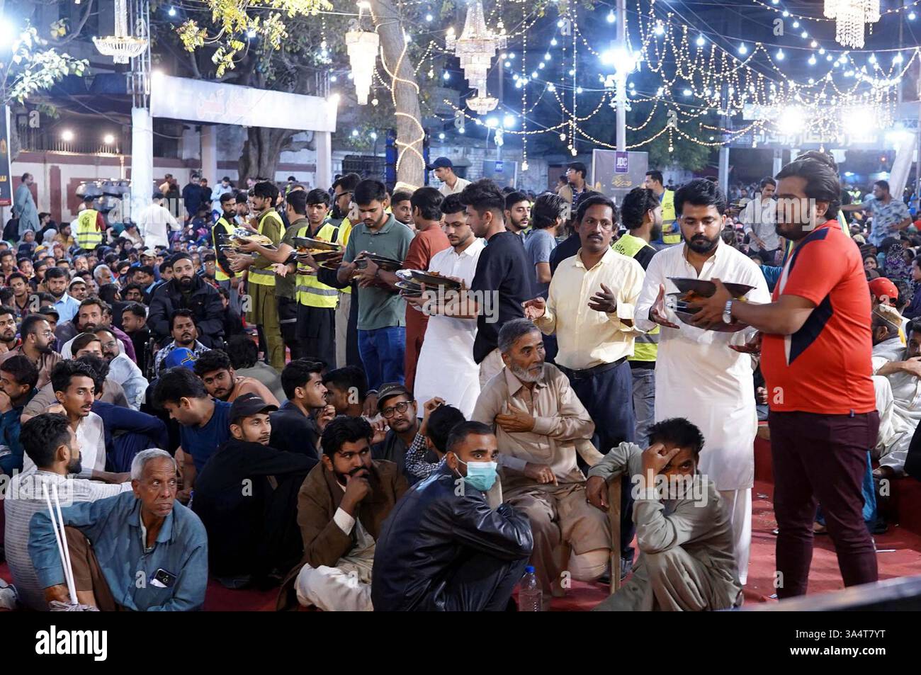 Faithful Muslims are breaking the fast (Iftar) under the supervision of ...
