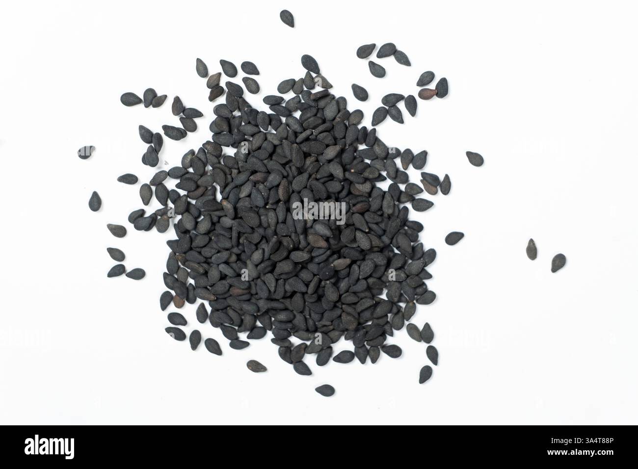 Black sesame seeds scattered on a white background macro top view Stock ...