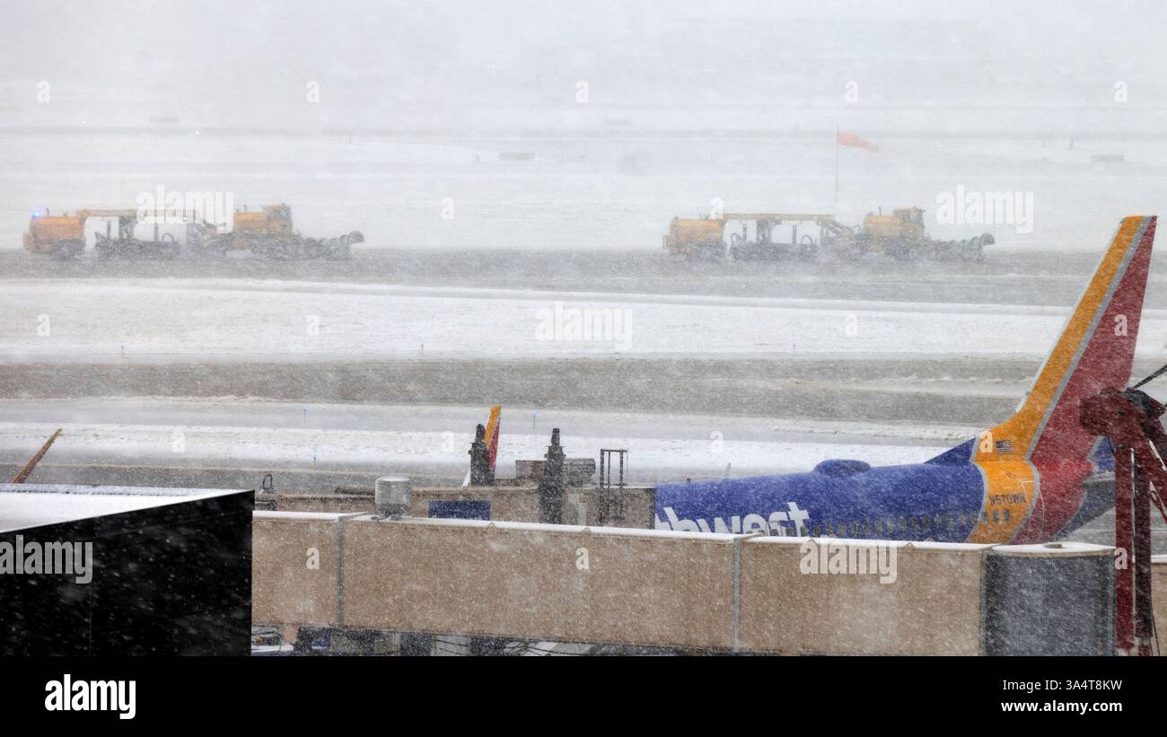 Trucks clear snow at Eppley Airfield during a blizzard in Omaha, Neb ...