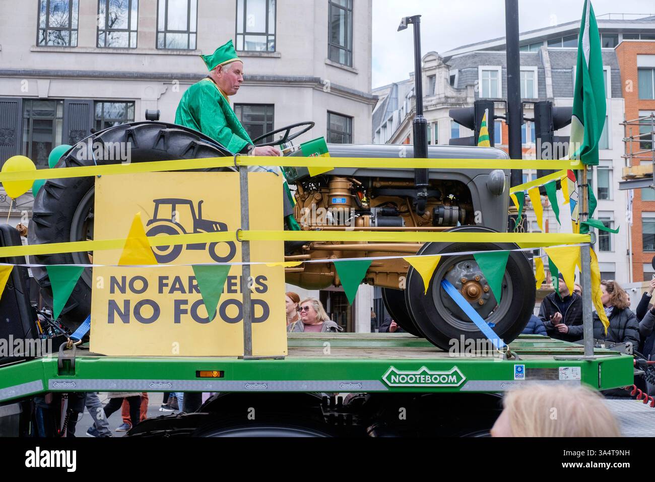 St Patrick's Day parade 2025, London, UK. Float carrying a tractor with ...