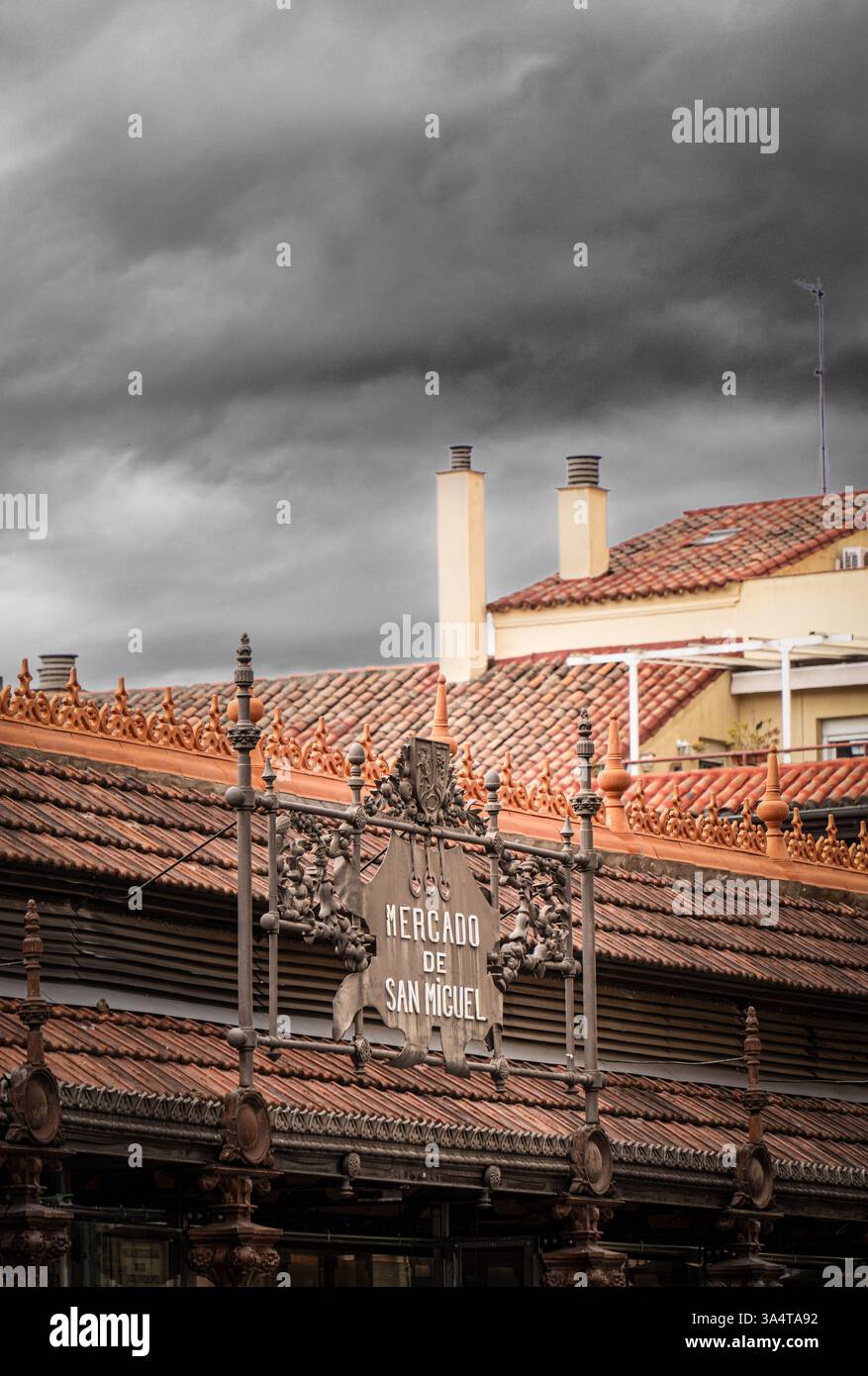 Mercado de san miguel sign hanging over the roof under a cloudy sky in ...