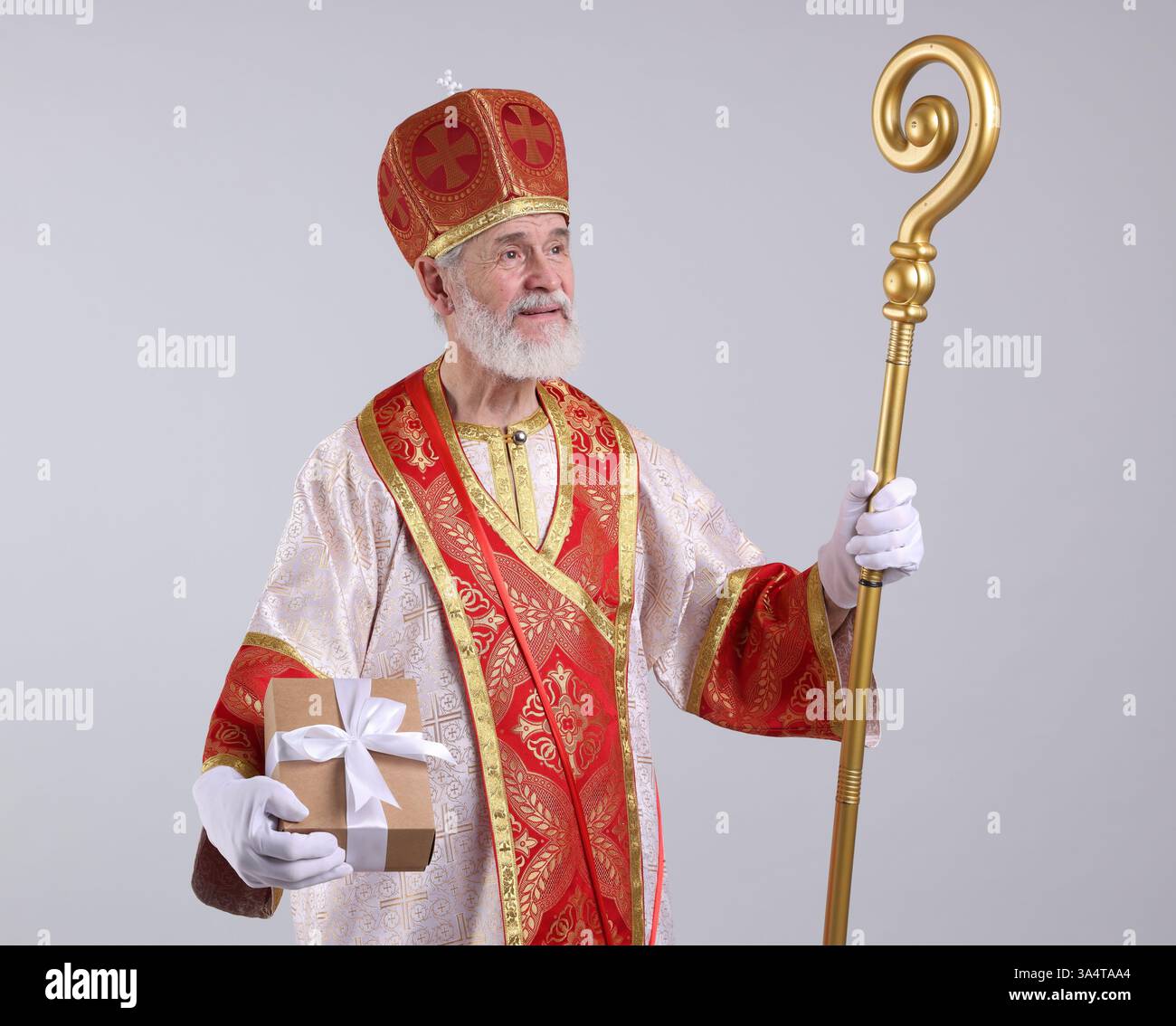 Saint Nicholas with gift on light grey background Stock Photo - Alamy