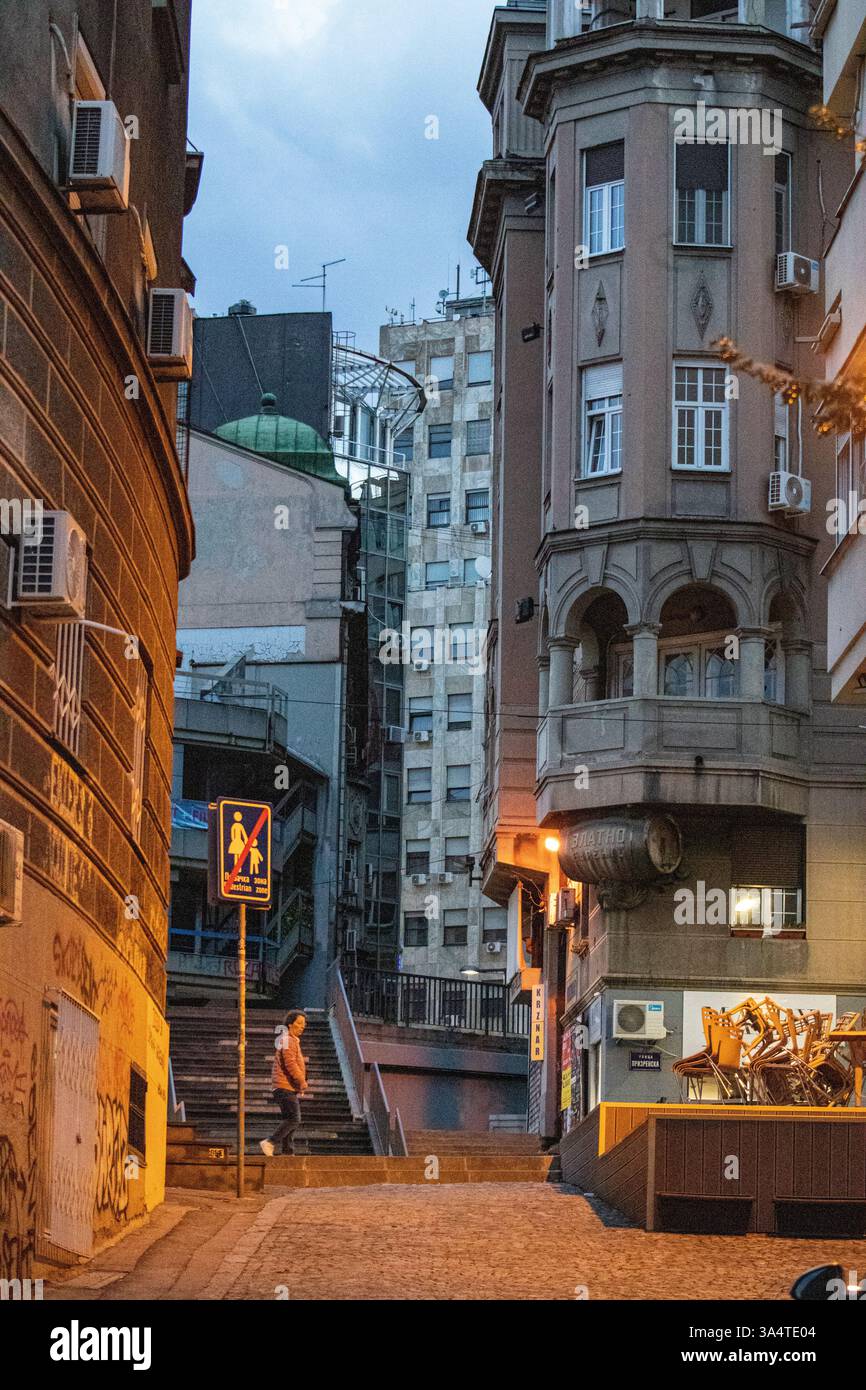 An urban street in the evening light features diverse architecture ...