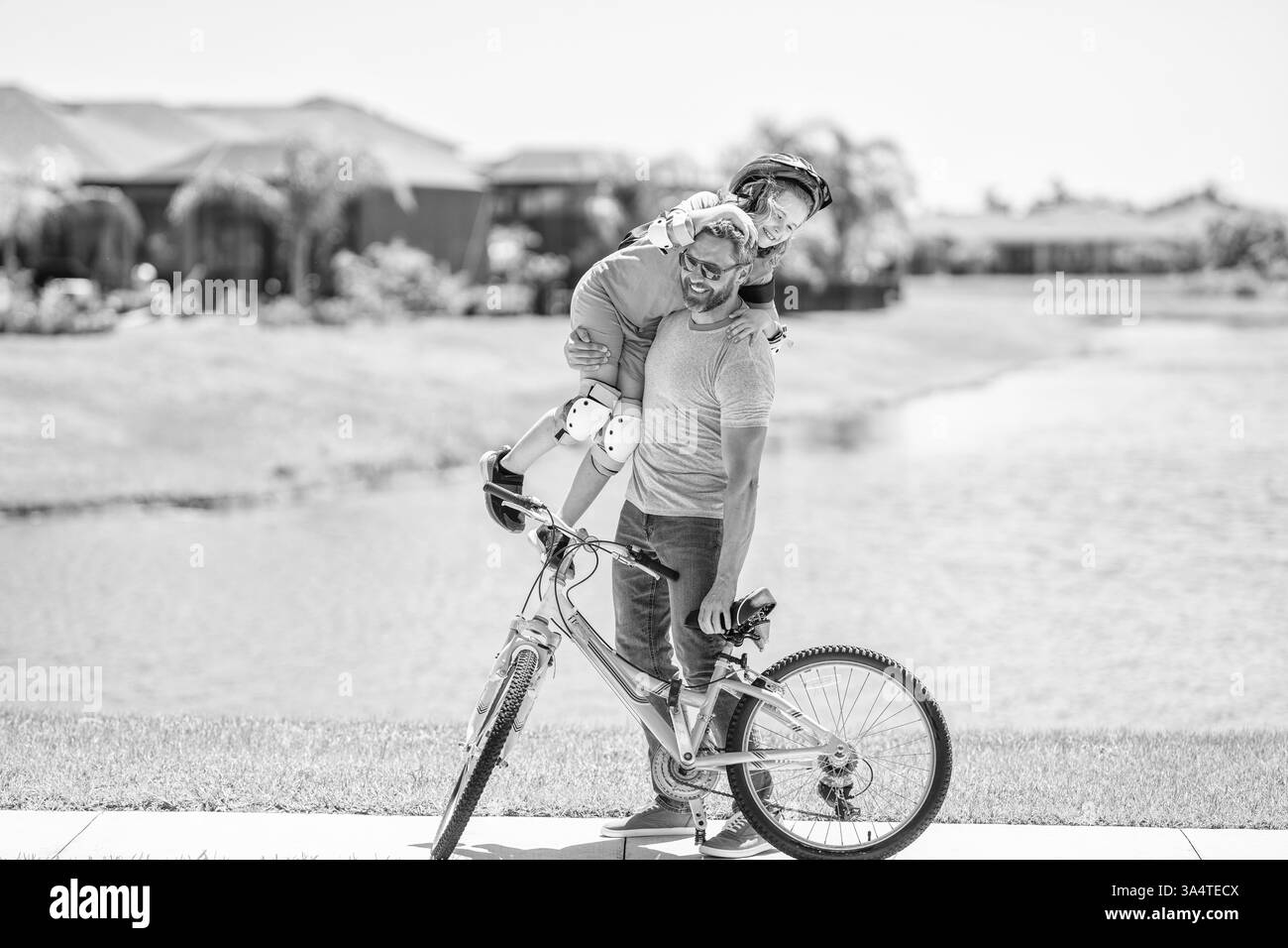 childhood of son supported by fathers care. father and son on bicycle ...