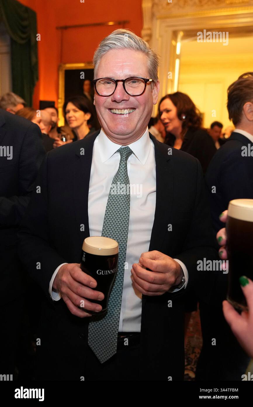 Britain's Prime Minister Keir Starmer holds a pint of Guiness during a ...
