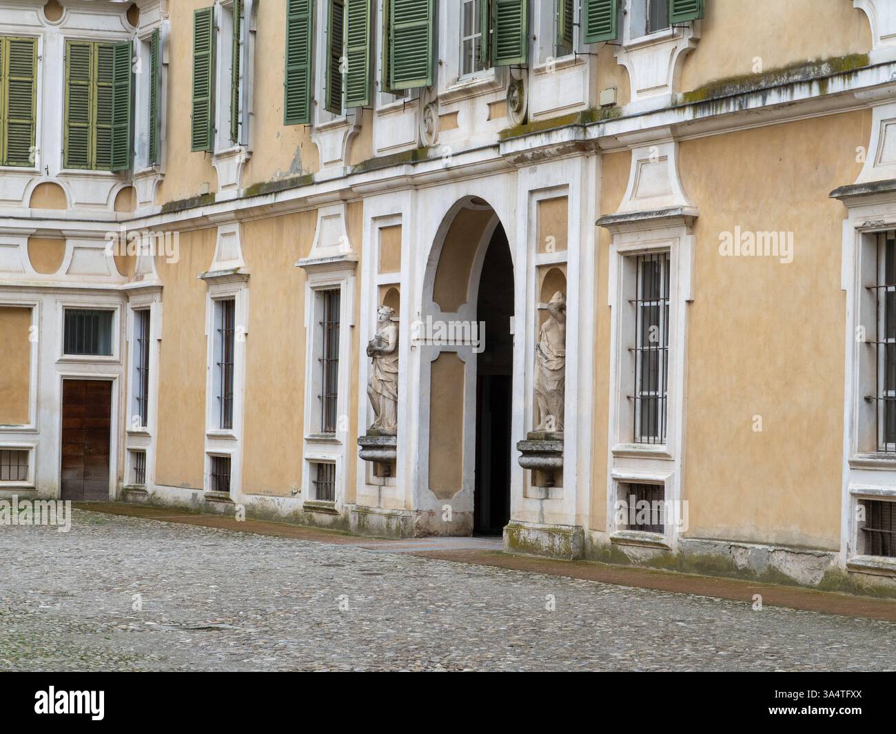 Colorno, Italy March 1st 2025 Cobblestone courtyard, arched entrance ...