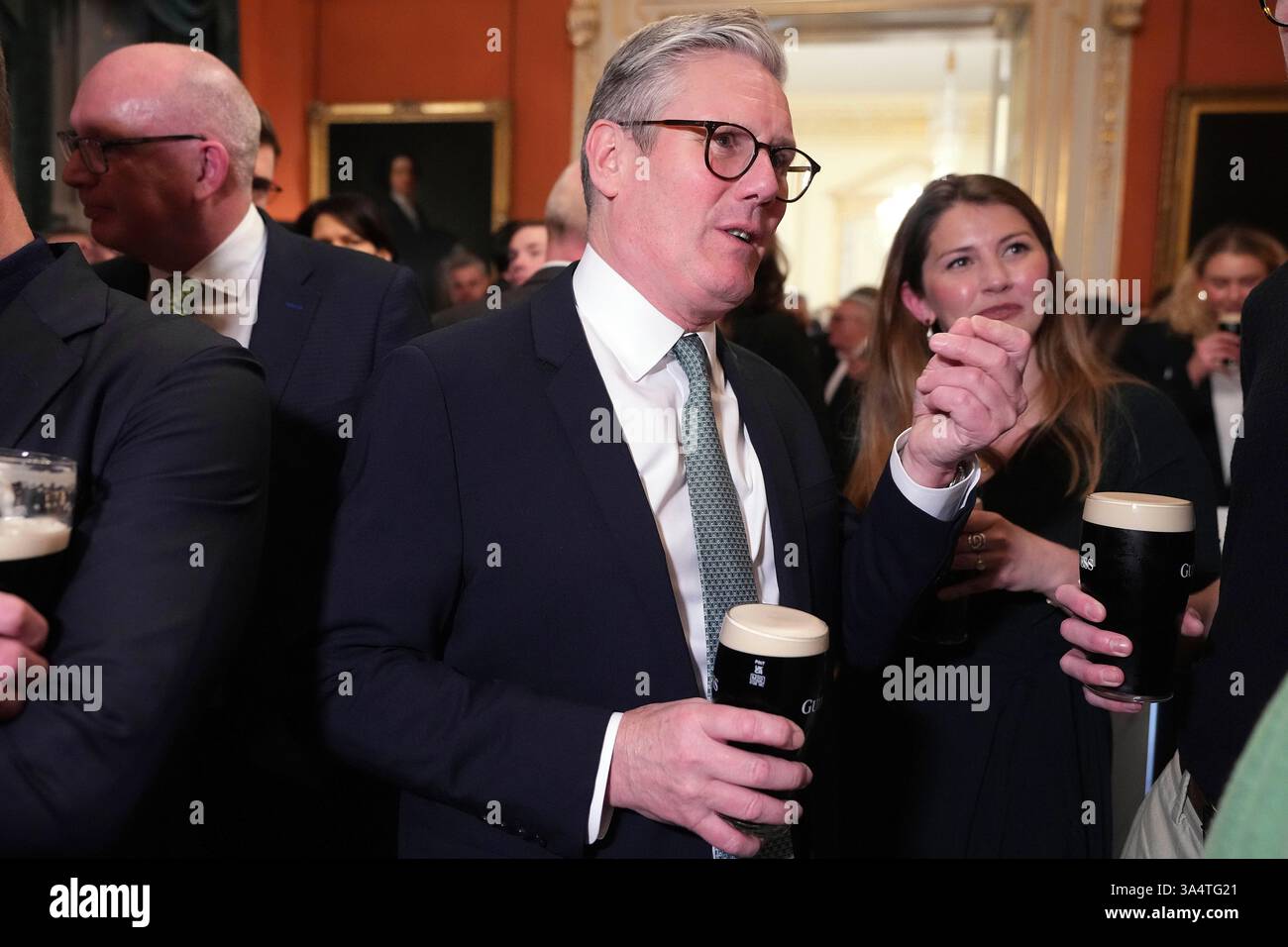 Britain's Prime Minister Keir Starmer holds a pint of Guiness during a ...