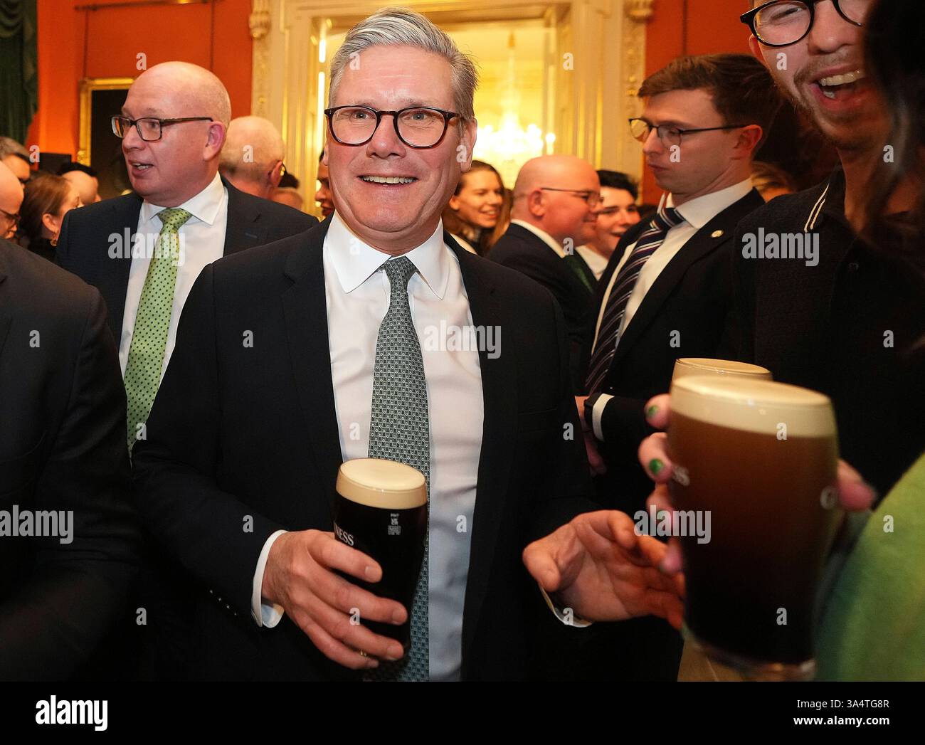Britain's Prime Minister Keir Starmer holds a pint of Guiness during a ...