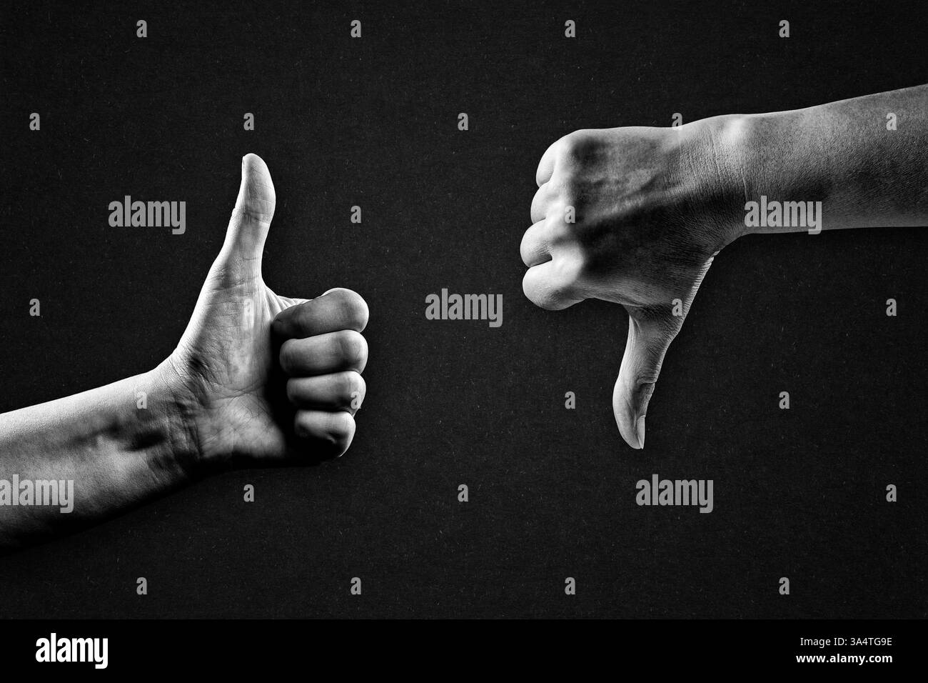 Hand Showing Thumb Up and Down Sign in Black and White on Textured ...