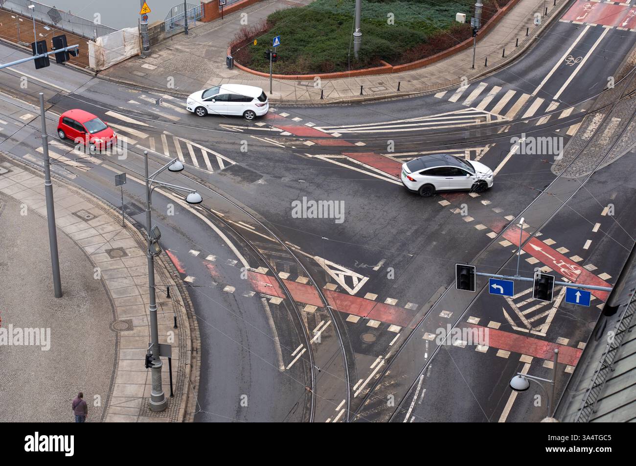 Aerial view of busy urban intersection with cars navigating tram tracks ...