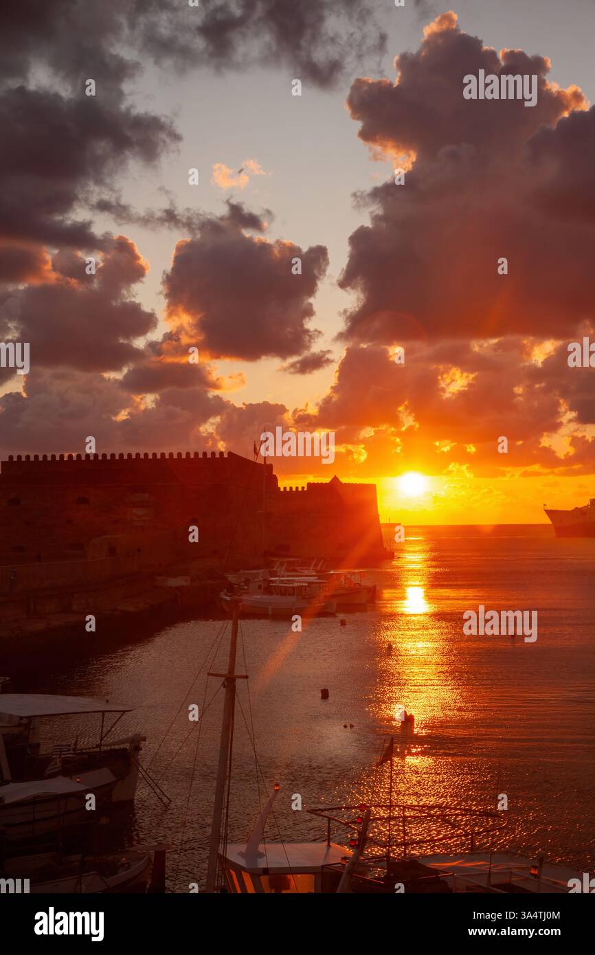 Stunning sunrise over the old port of Heraklion, Crete, with majestic ...