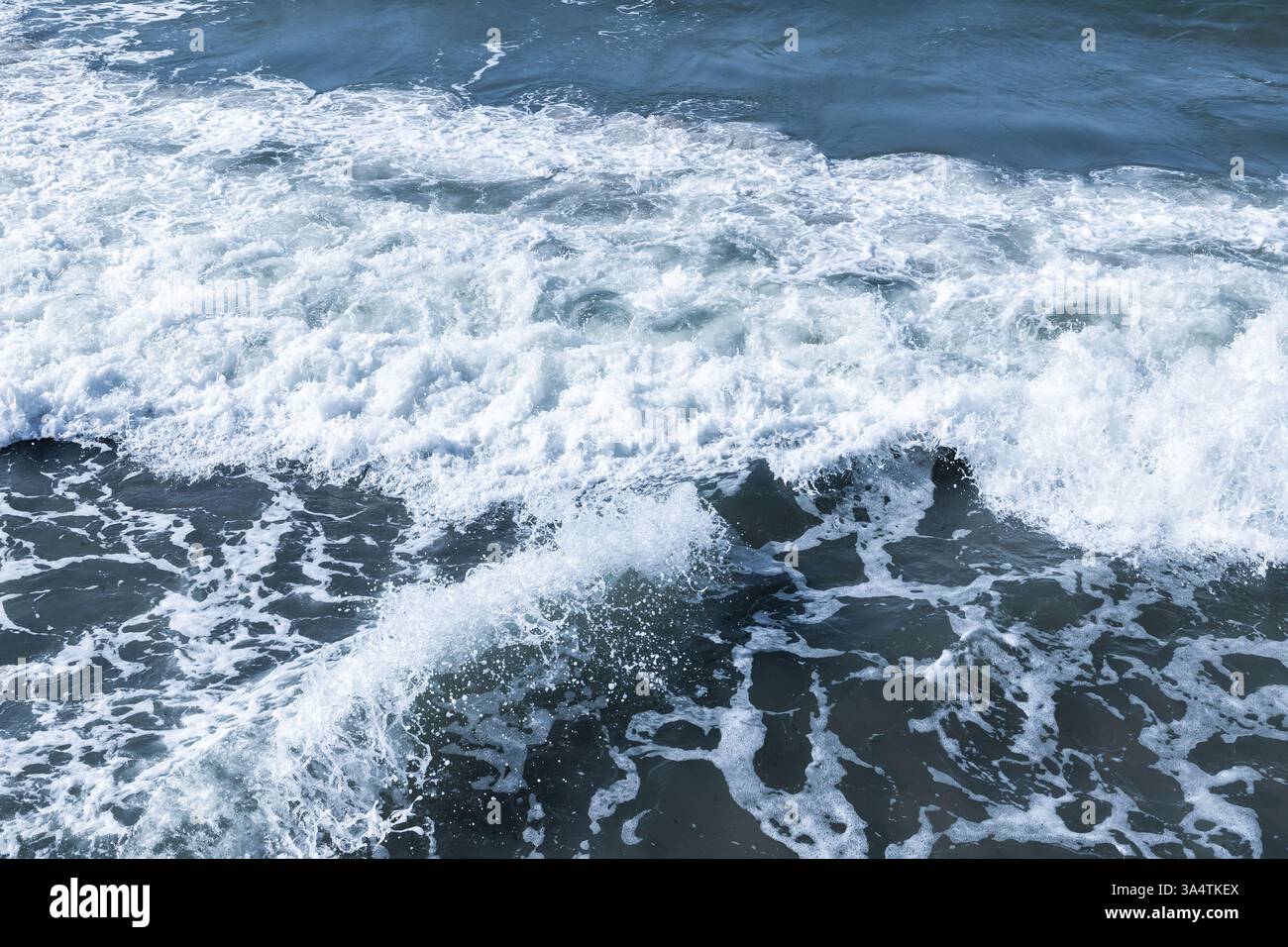 Ocean waves surging with foam against the shore show nature dynamic ...