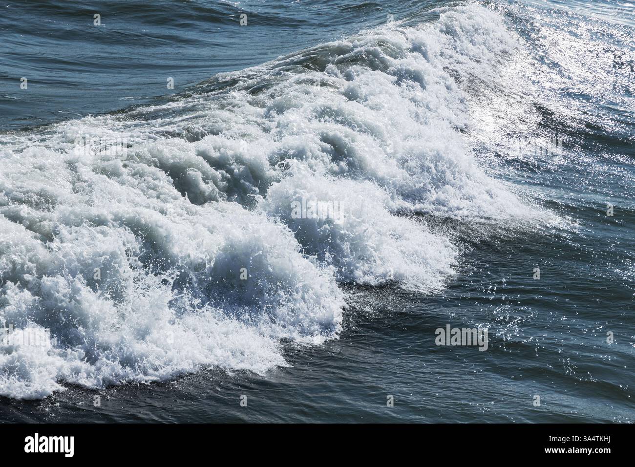 A captivating image of ocean waves breaking with white foam, reflecting ...
