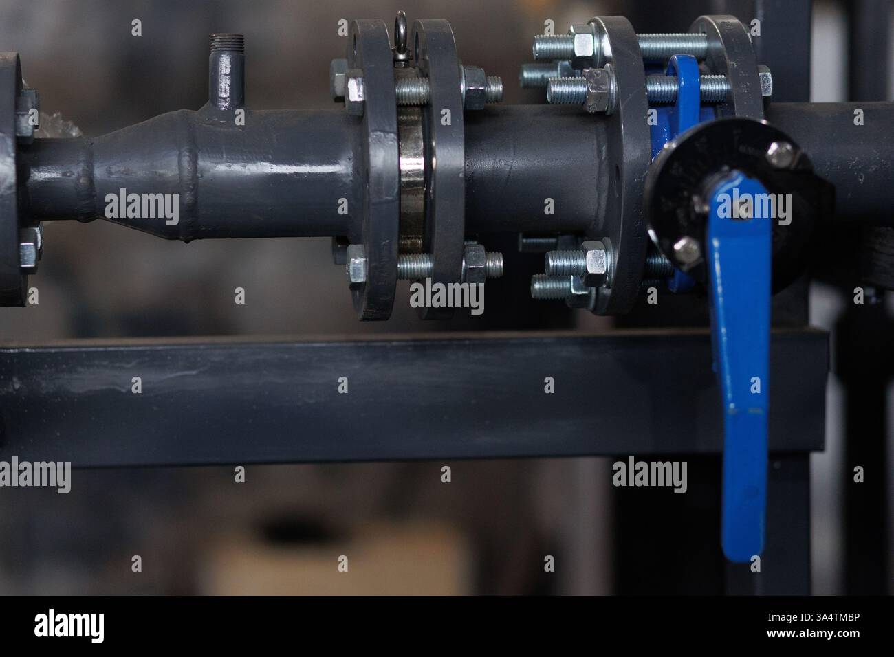 Detailed focus on a complex piping assembly with metallic valves and ...