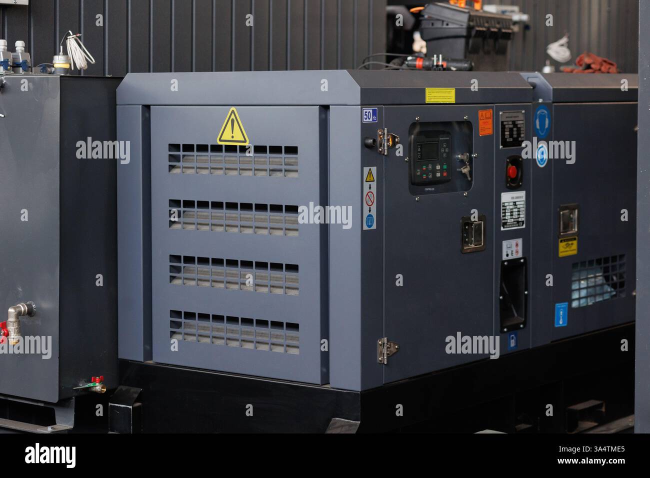 An industrial generator hums quietly in the workshop, providing ...