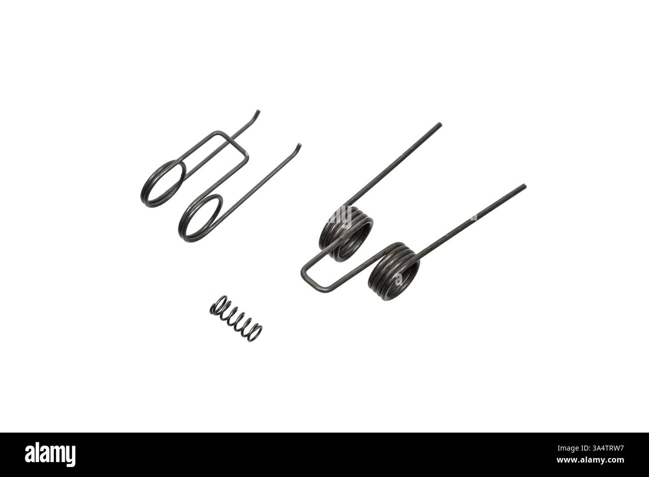 Three metal springs, including torsion and compression types, with ...