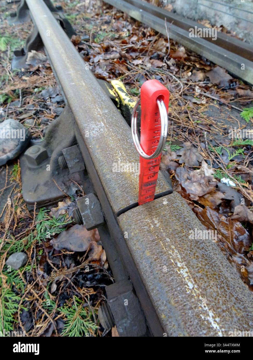 Measuring the expansion gap between rails at a joint on a railway line ...