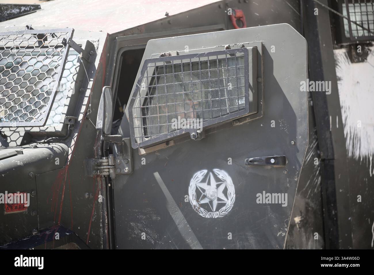 An Israeli soldier is seen inside a military vehicle during a raid on ...