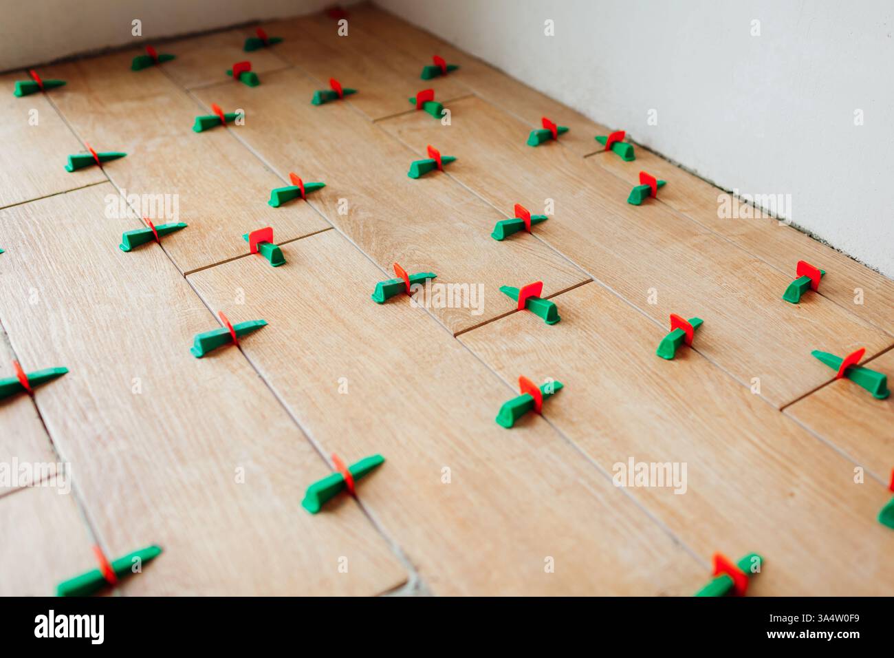 Tile leveling system with plastic clips and wedges. Wood effect narrow ...