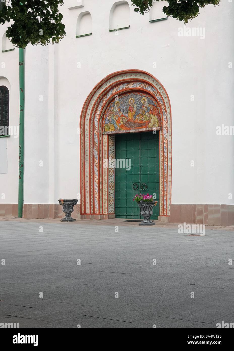 Church entrance gate with green wooden door. Old church with painted ...