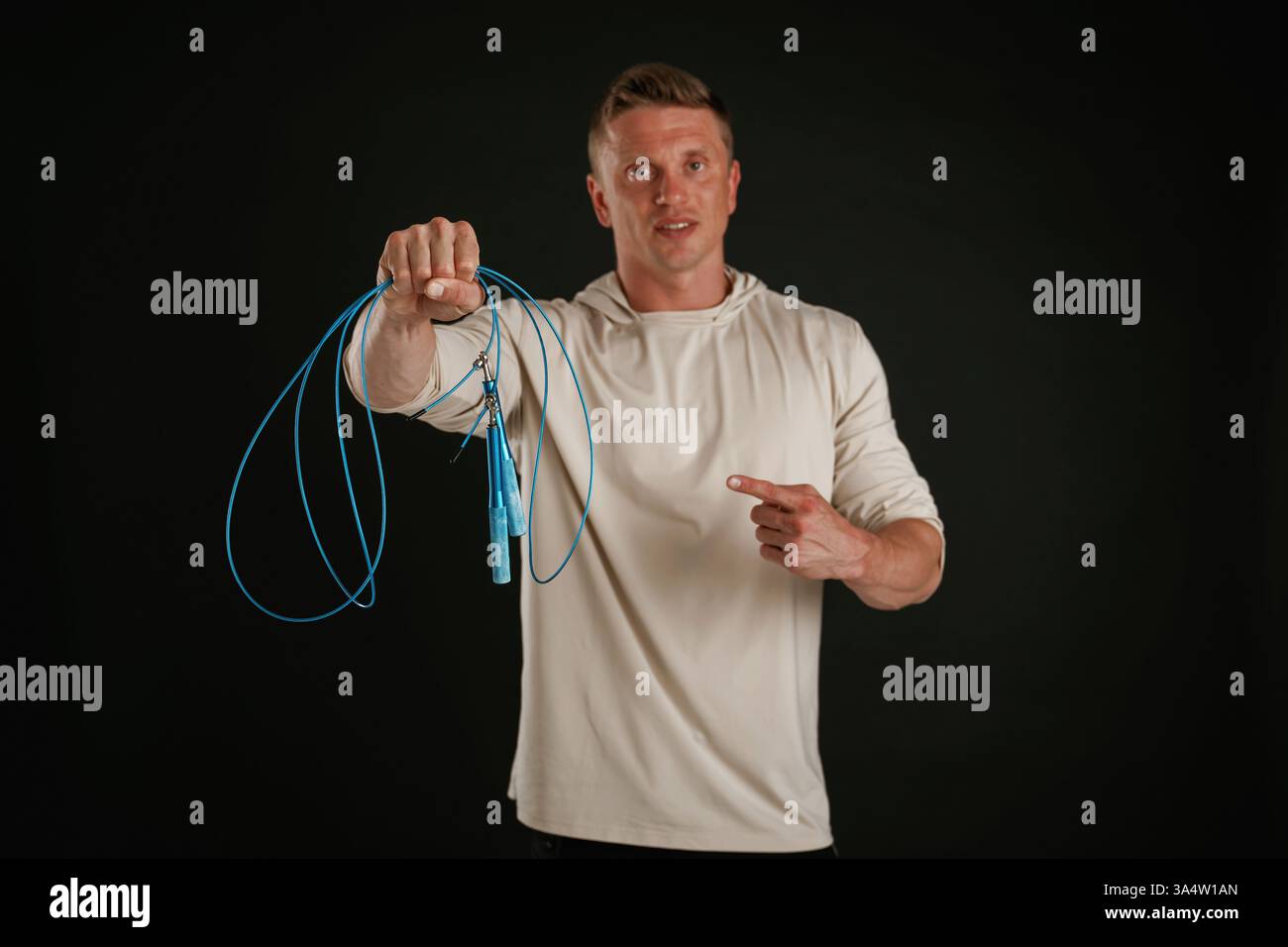 Try this, showing jumping ropes, fitness. Man is against background in ...