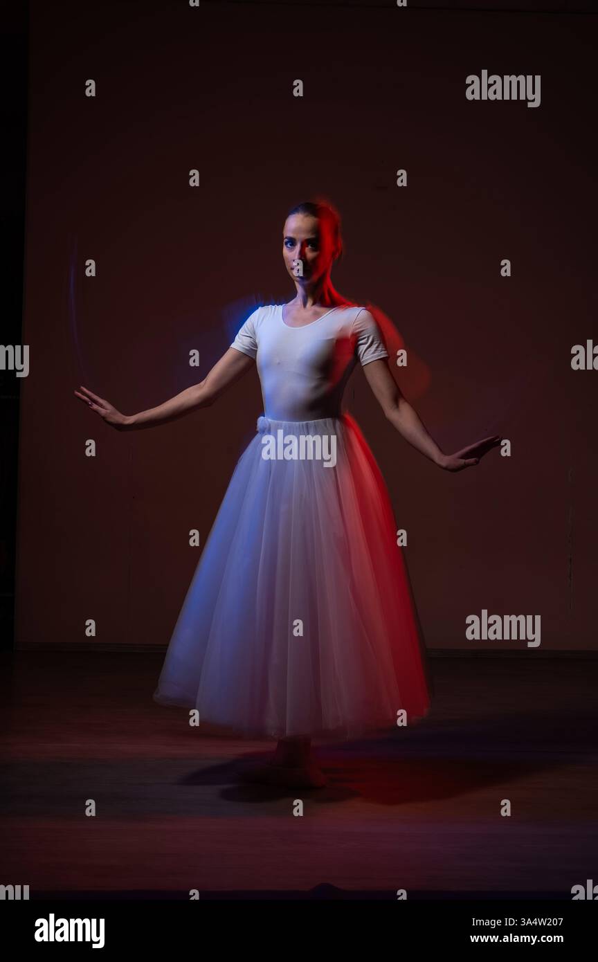 Caucasian woman dancing classical dance in tutu . Long exposure photo ...