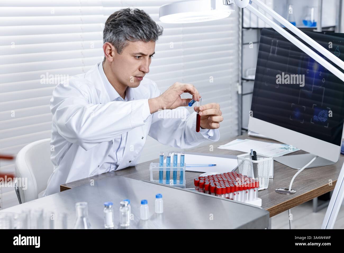 Scientist with test tubes working in laboratory Stock Photo - Alamy