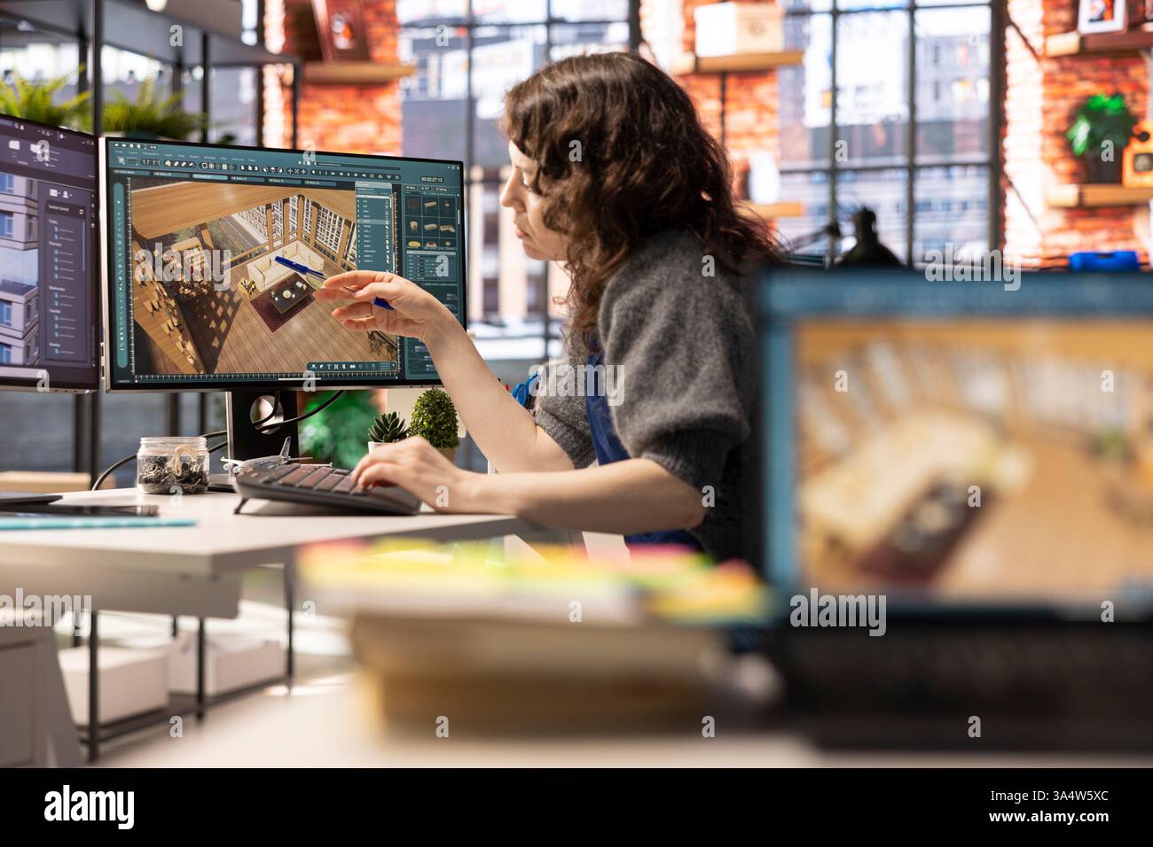 Woman developer works on an interior design project using CAD software ...