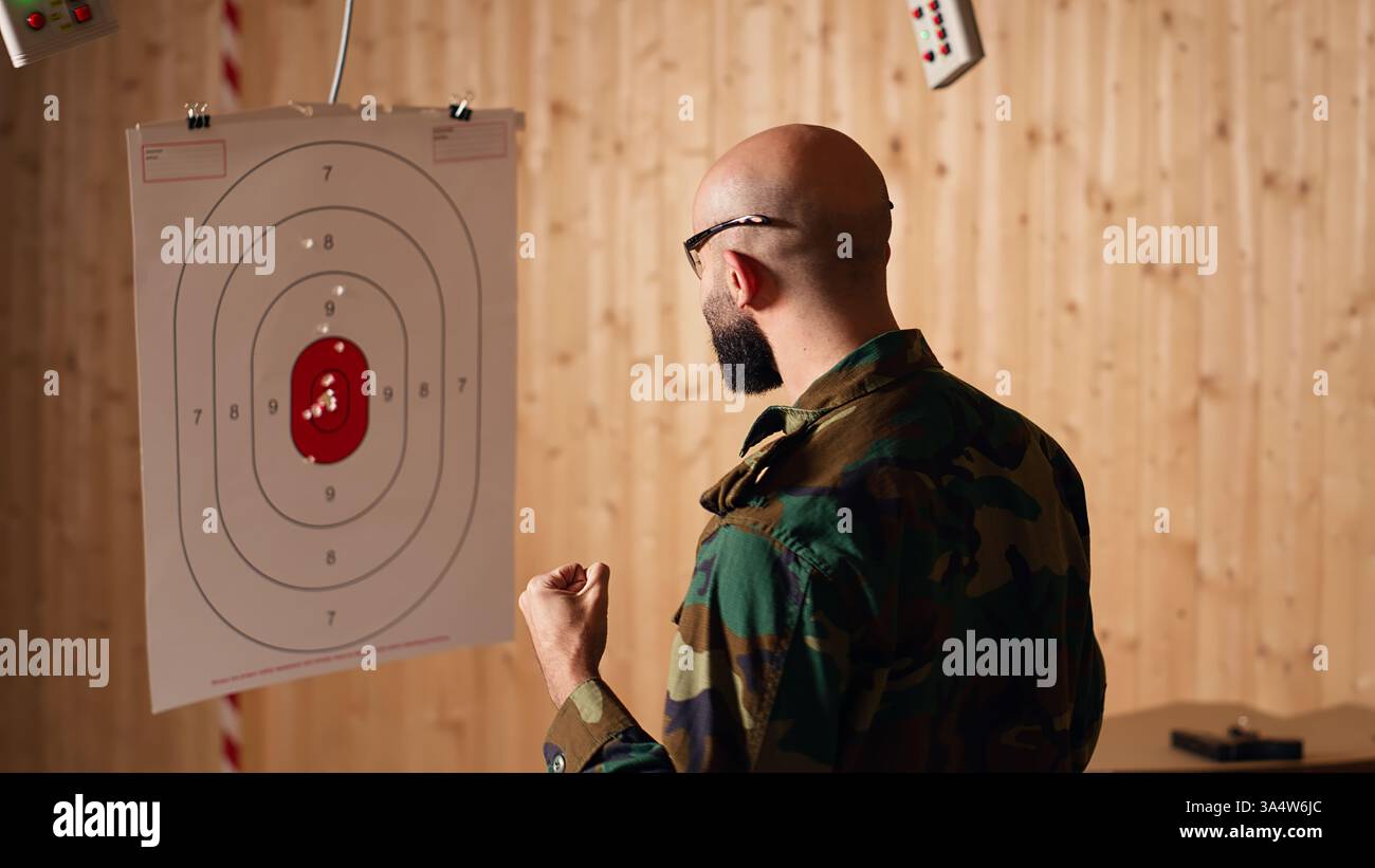 Army soldier in shooting range reloads pistol, shooting target, testing ...