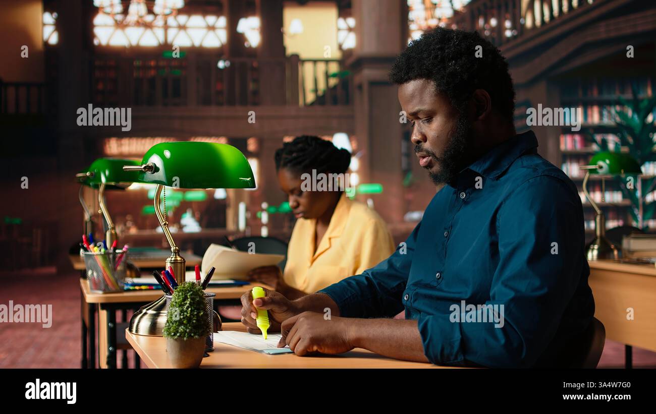 Black university student highlighting relevant phrases to learn the ...