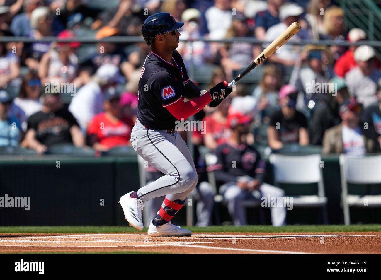 Cleveland Guardians' Brayan Rocchio follows thorugh on a base hit ...