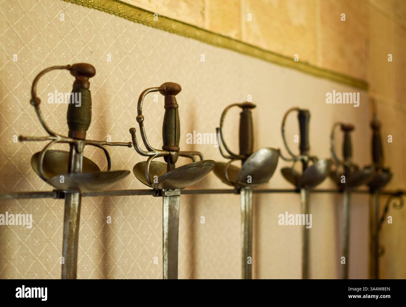 Set of Medieval Swords Exposed with a White Background of Castle wall ...