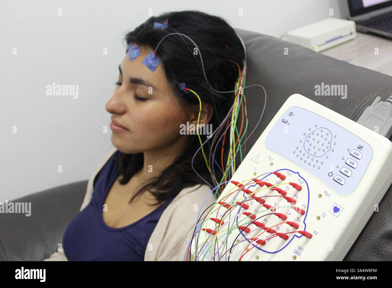 20-year-old Latin brunette woman undergoes EEG electroencephalogram neurological examination ...