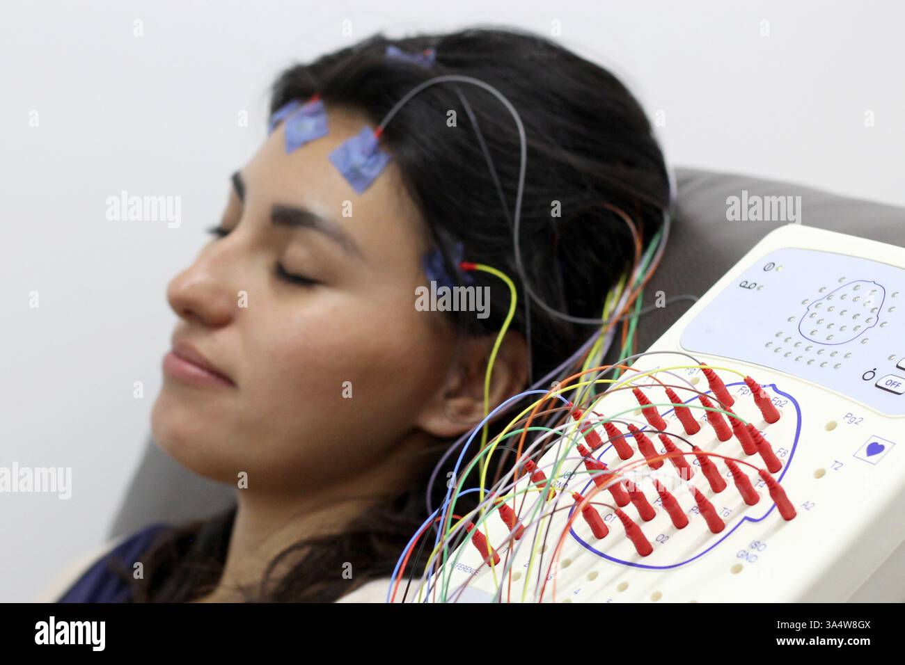 20-year-old Latin brunette woman undergoes EEG electroencephalogram ...