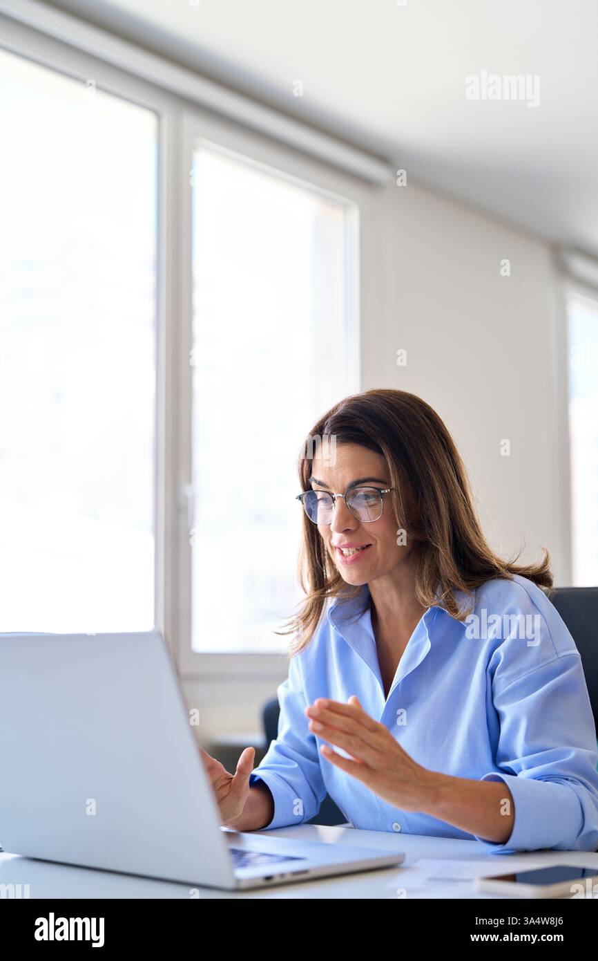Busy mature woman executive having hybrid office meeting video call ...
