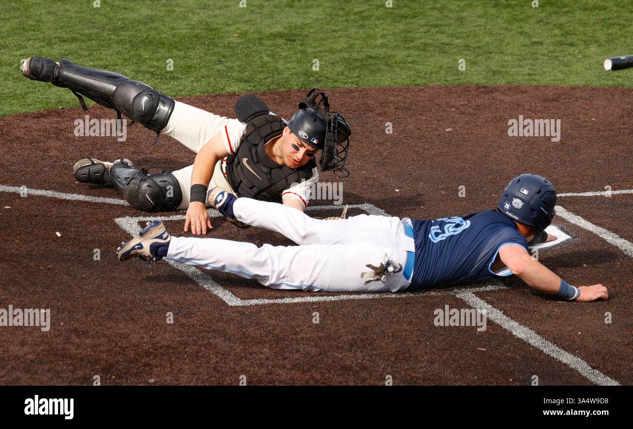 Villanova baserunner Aidan Barry tags home plate for a run while being ...