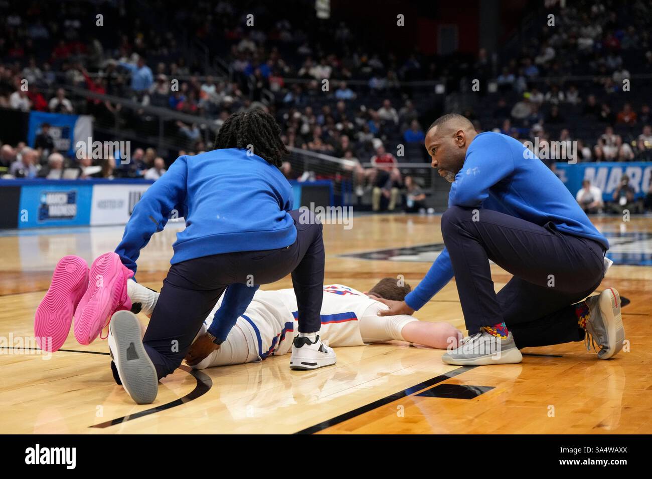 American University head coach Duane Simpkins, right, comforts player ...