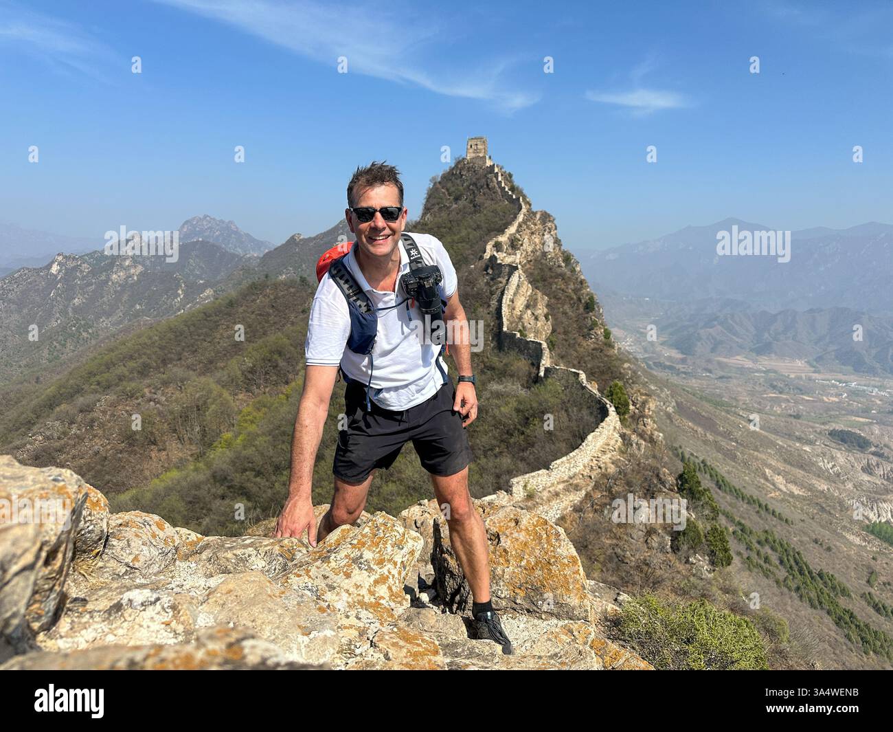A tourist hikes on the Simatai Great Wall, a well-preserved section of ...