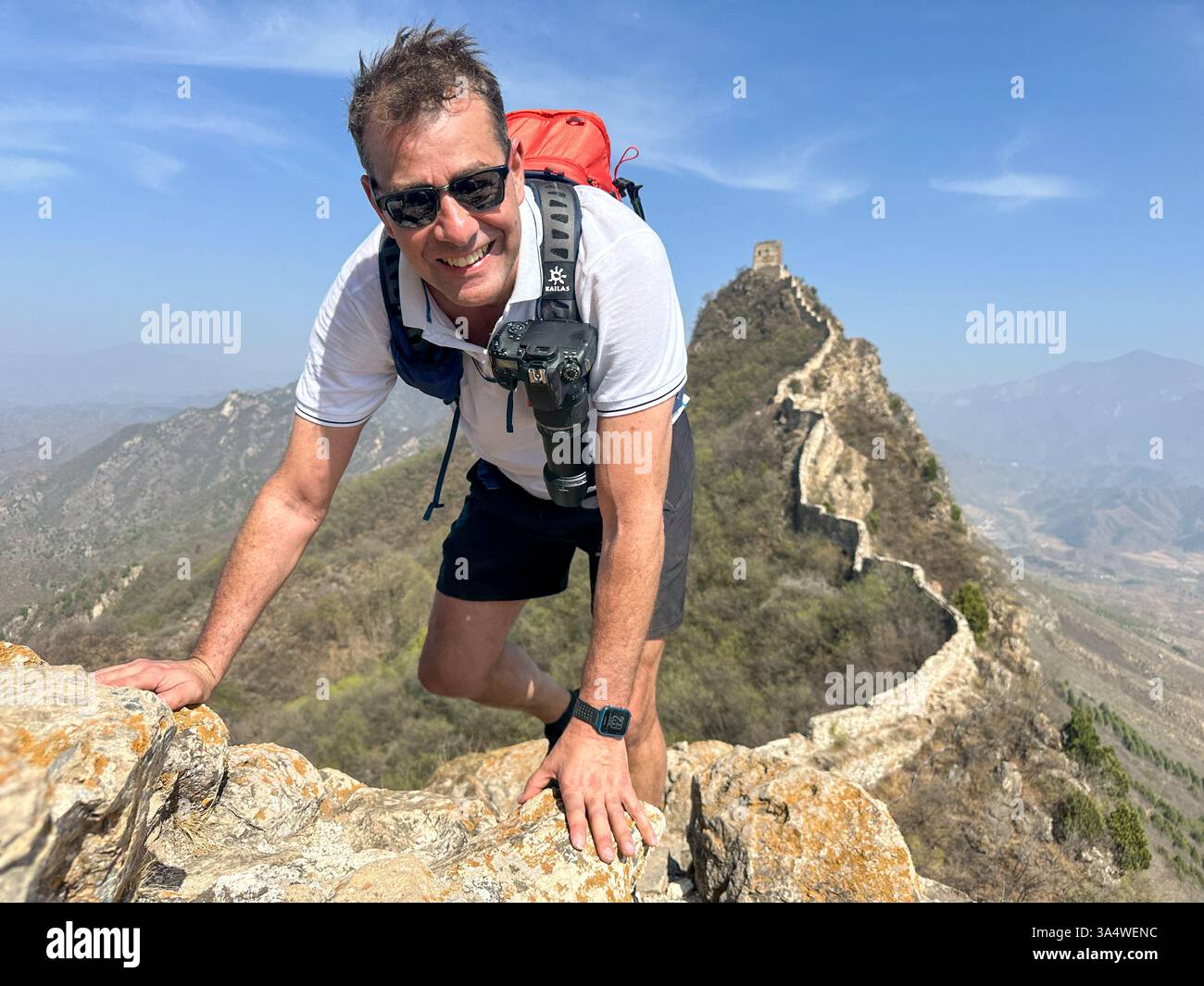 A tourist hikes on the Simatai Great Wall, a well-preserved section of ...
