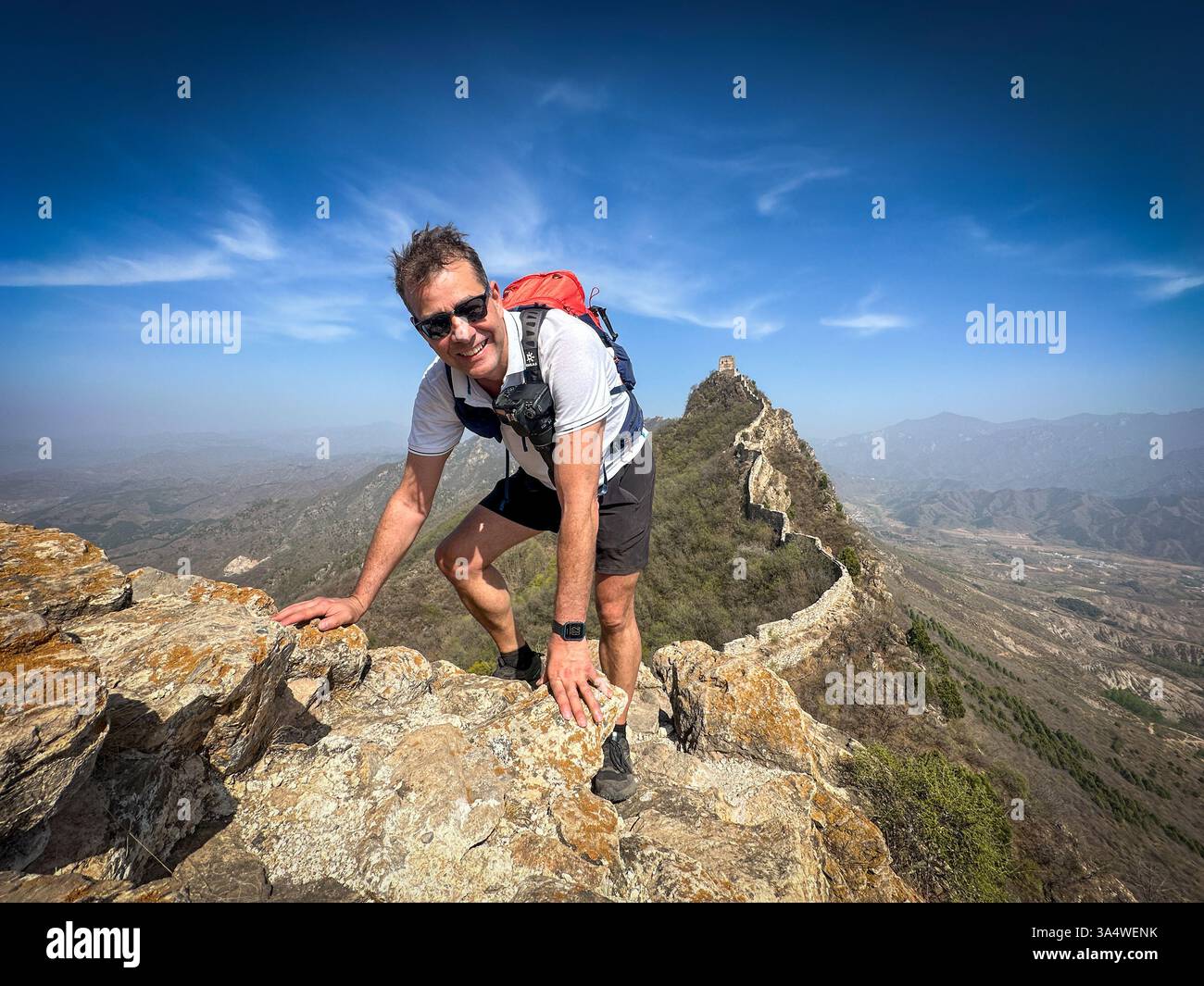A tourist hikes on the Simatai Great Wall, a well-preserved section of ...