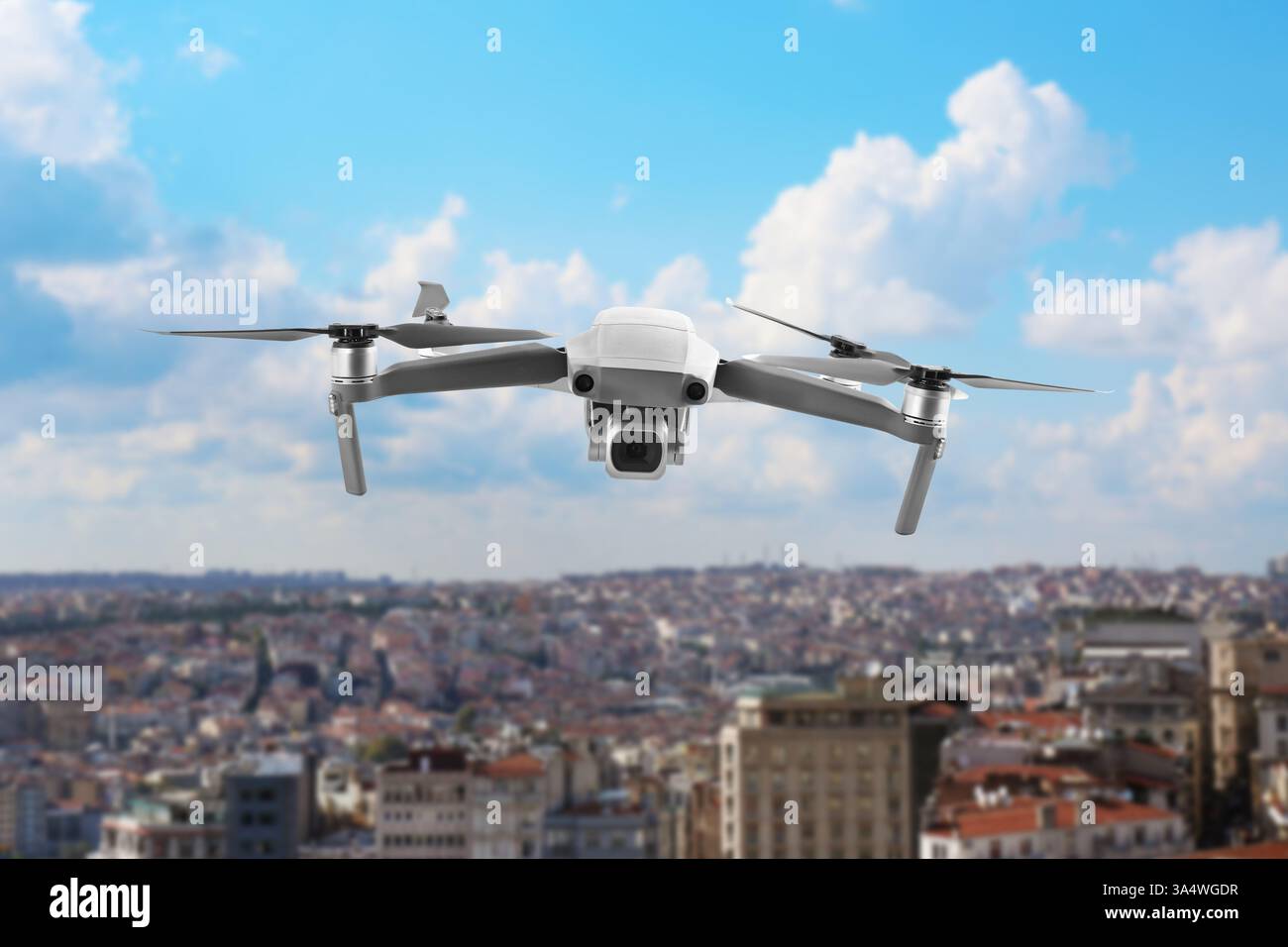 Drone with camera flying over city. Unmanned aerial vehicle for ...