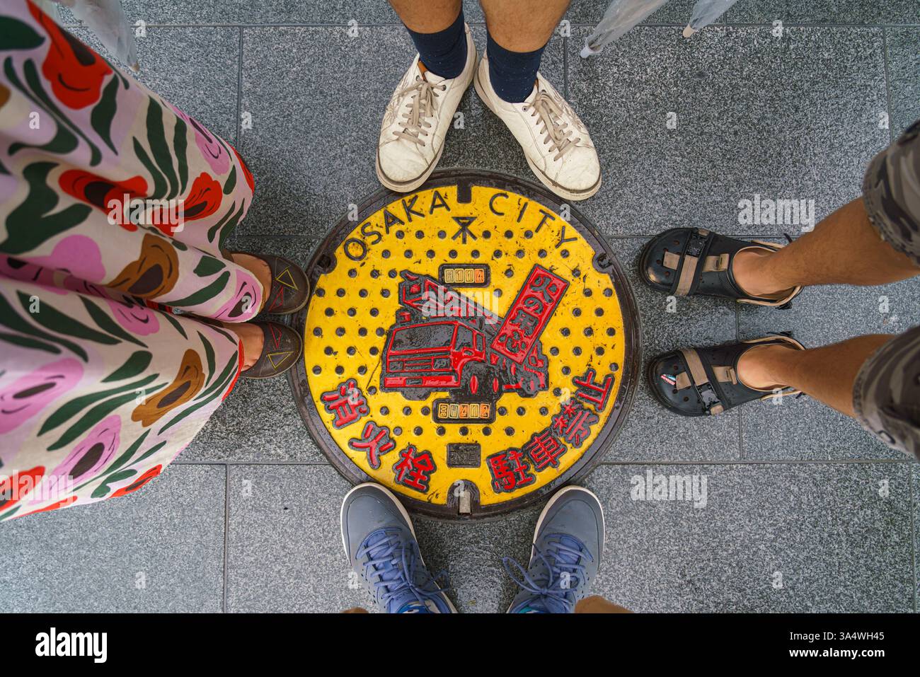 Osaka, Japan - Sep 22 2024, An overhead view of a manhole cover withred ...