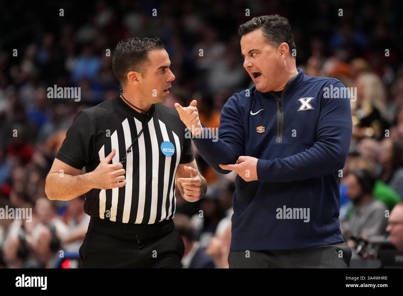 Xavier head coach Sean Miller, right, speaks with an official during ...