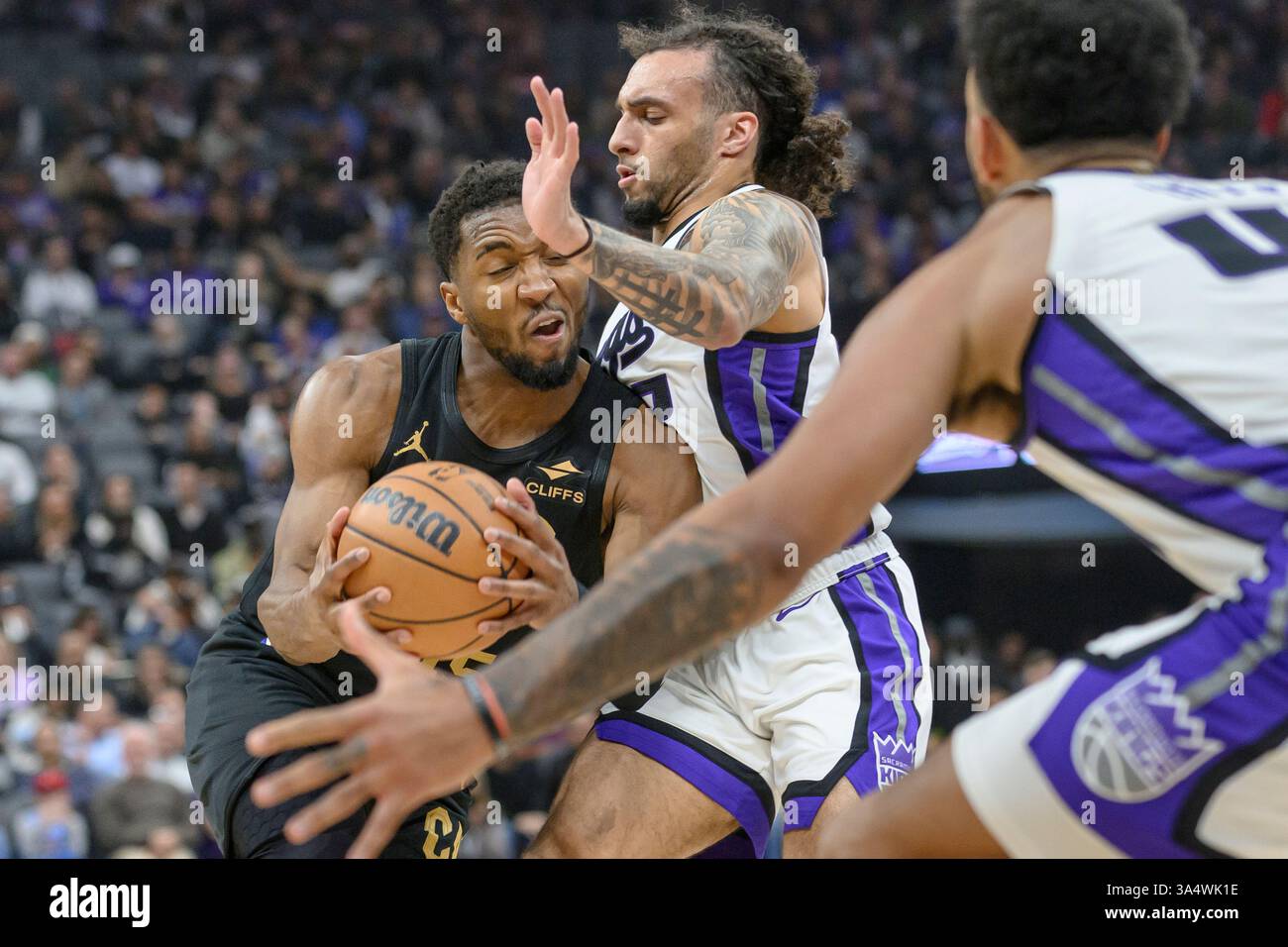 Cleveland Cavaliers guard Donovan Mitchell, left, drives past ...