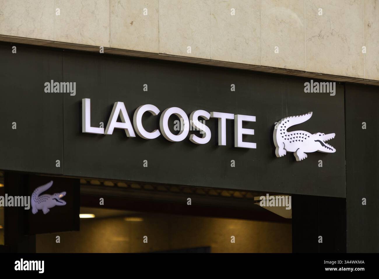 Lacoste logo sign. White letters and crocodile. René Lacoste, a ...