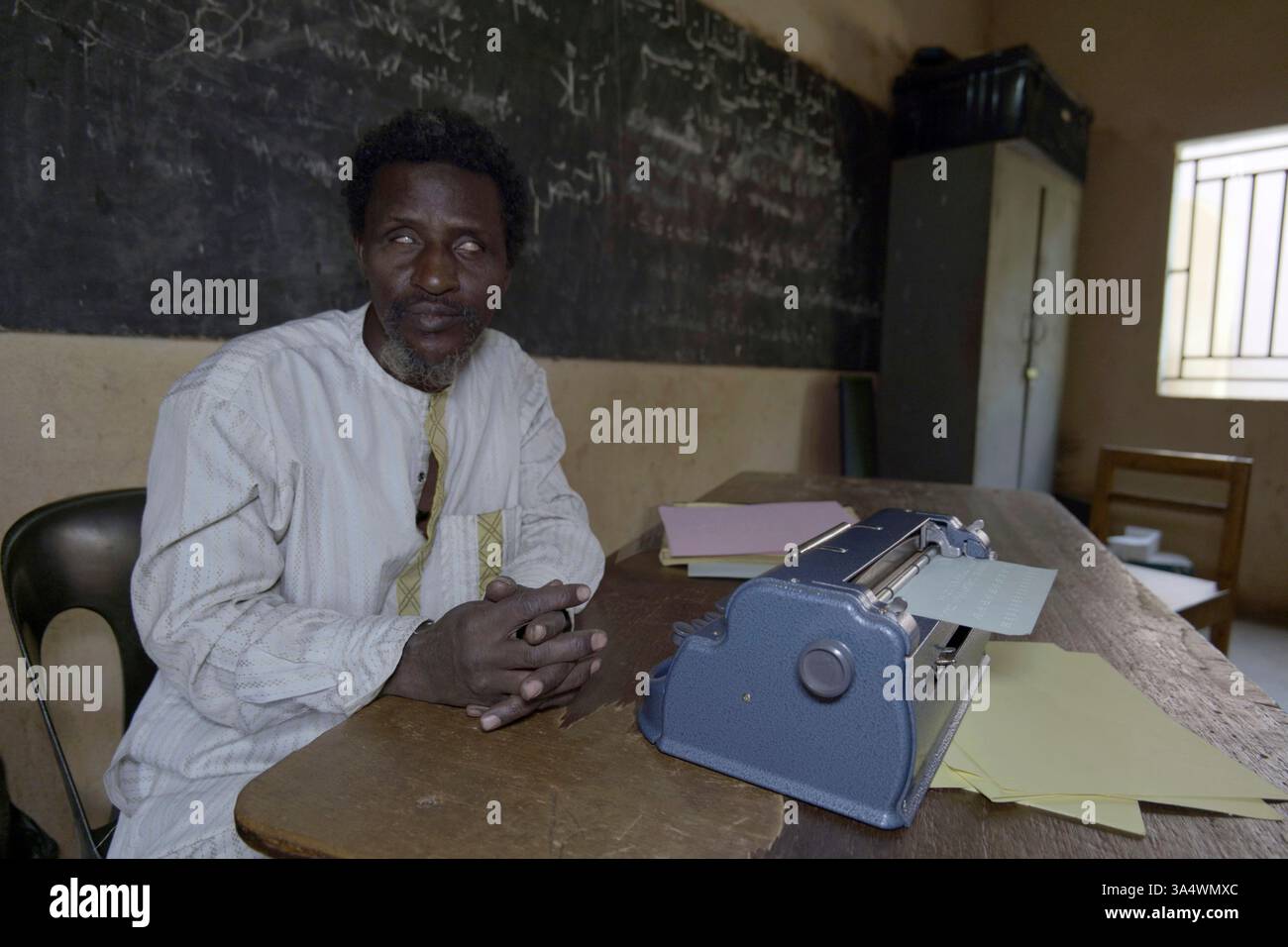 Ali Moustapha Dicko, who teaches at the institute for the blind, shows ...