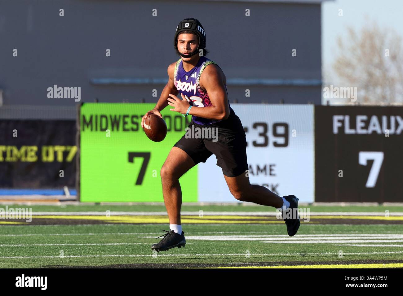 Midwest Boom quarterback Jonas Williams (13) scrambles with the ball ...