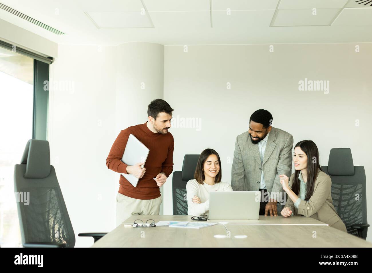 A diverse group of professionals engages in a dynamic brainstorming ...